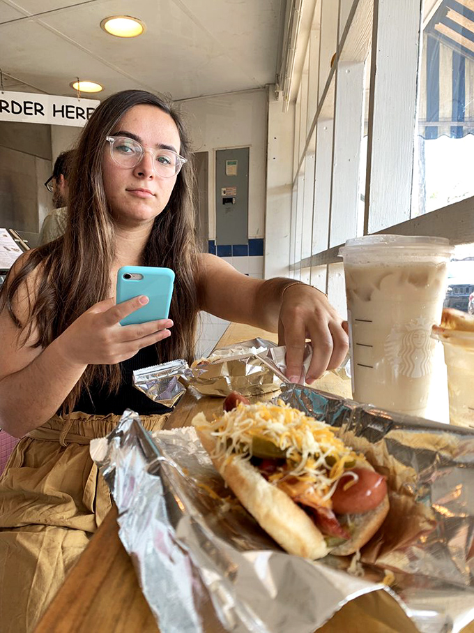 A masterclass in hot dog architecture: cheese, peppers, and a perfectly grilled dog create the kind of sandwich poets should write sonnets about.