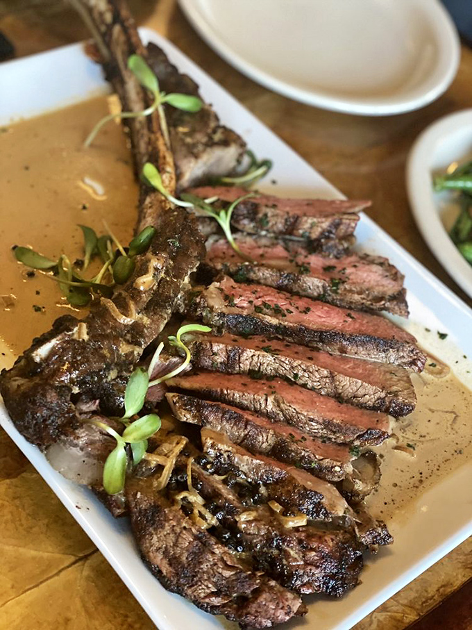 This tomahawk steak is sliced with such precision it could double as a demonstration in geometry class, only infinitely more delicious.