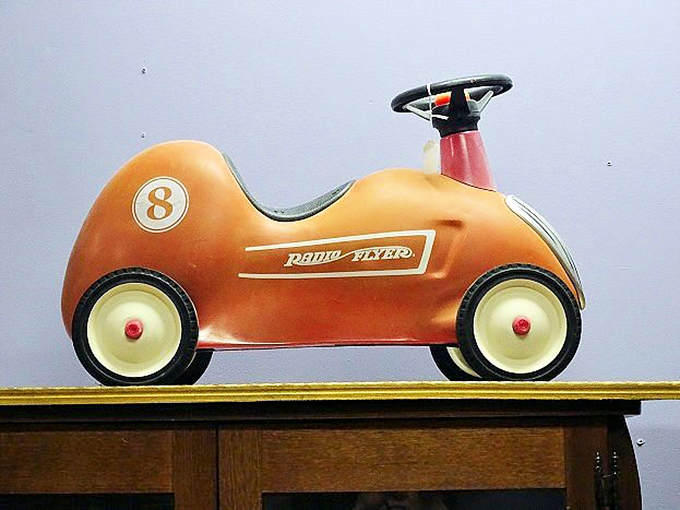 A Radio Flyer ride-on car that probably launched a thousand childhood adventures. Today's kids have iPads; yesterday's had wheels and imagination.
