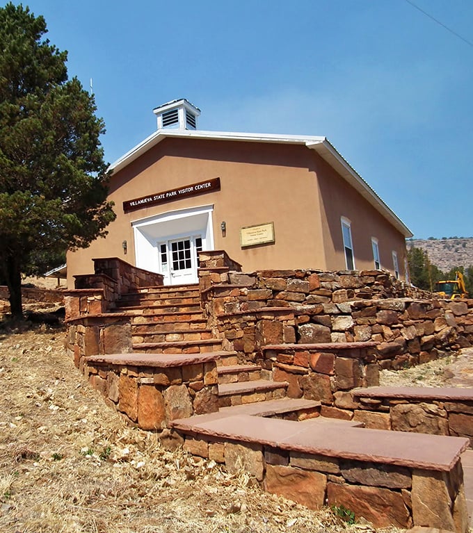 The visitor center blends seamlessly into the landscape, its adobe style and stone steps echoing the natural architecture of the canyon.