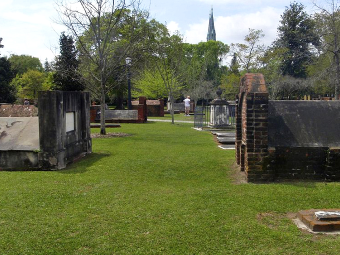 Perfectly manicured pathways invite contemplative strolls among above-ground tombs that resemble miniature houses for the departed.