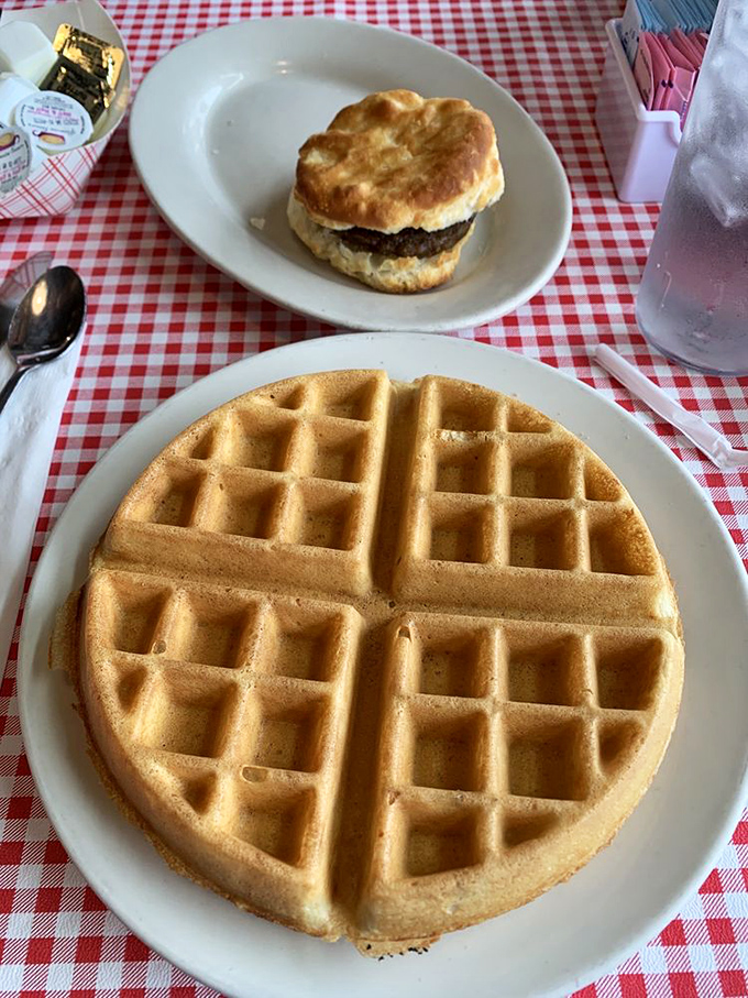 The perfect diner duo: a golden Belgian waffle with perfect grid precision and a biscuit sandwich that means business.