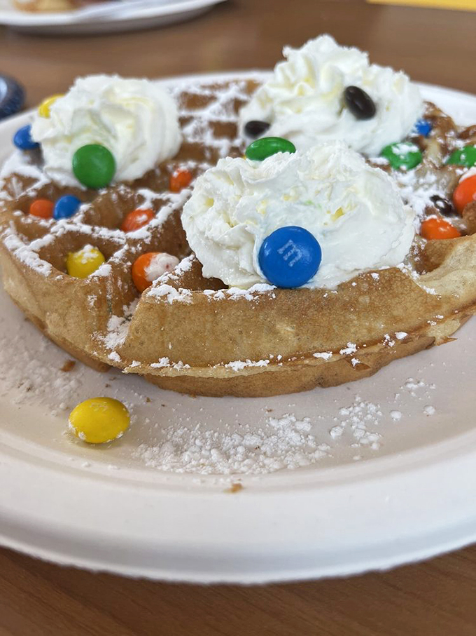 Who says waffles can't be playful? This whimsical creation with M&Ms and whipped cream proves breakfast can be both nostalgic and Instagram-worthy.