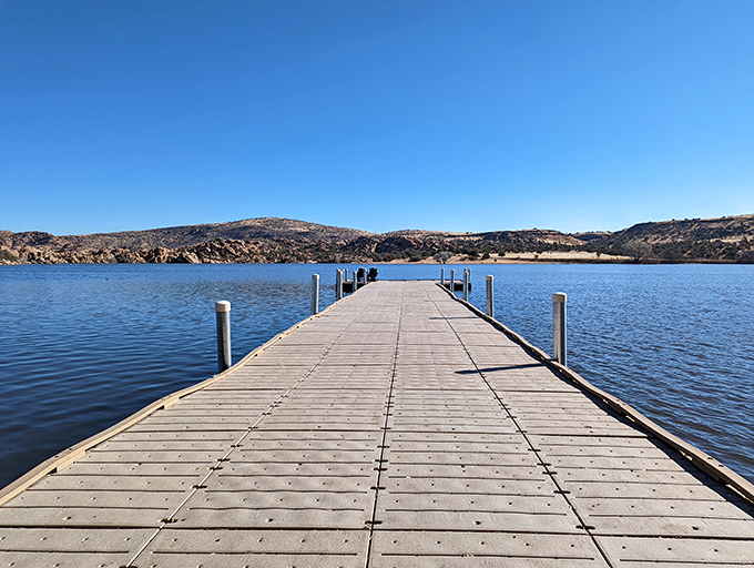 This wooden dock stretches into Watson Lake like an invitation to adventure, pointing the way to granite-framed horizons beyond.