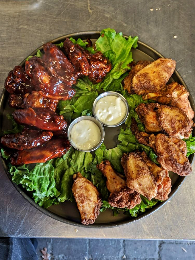 A platter that settles the great wing debate: why choose one style when you can have both saucy and crispy on the same plate?