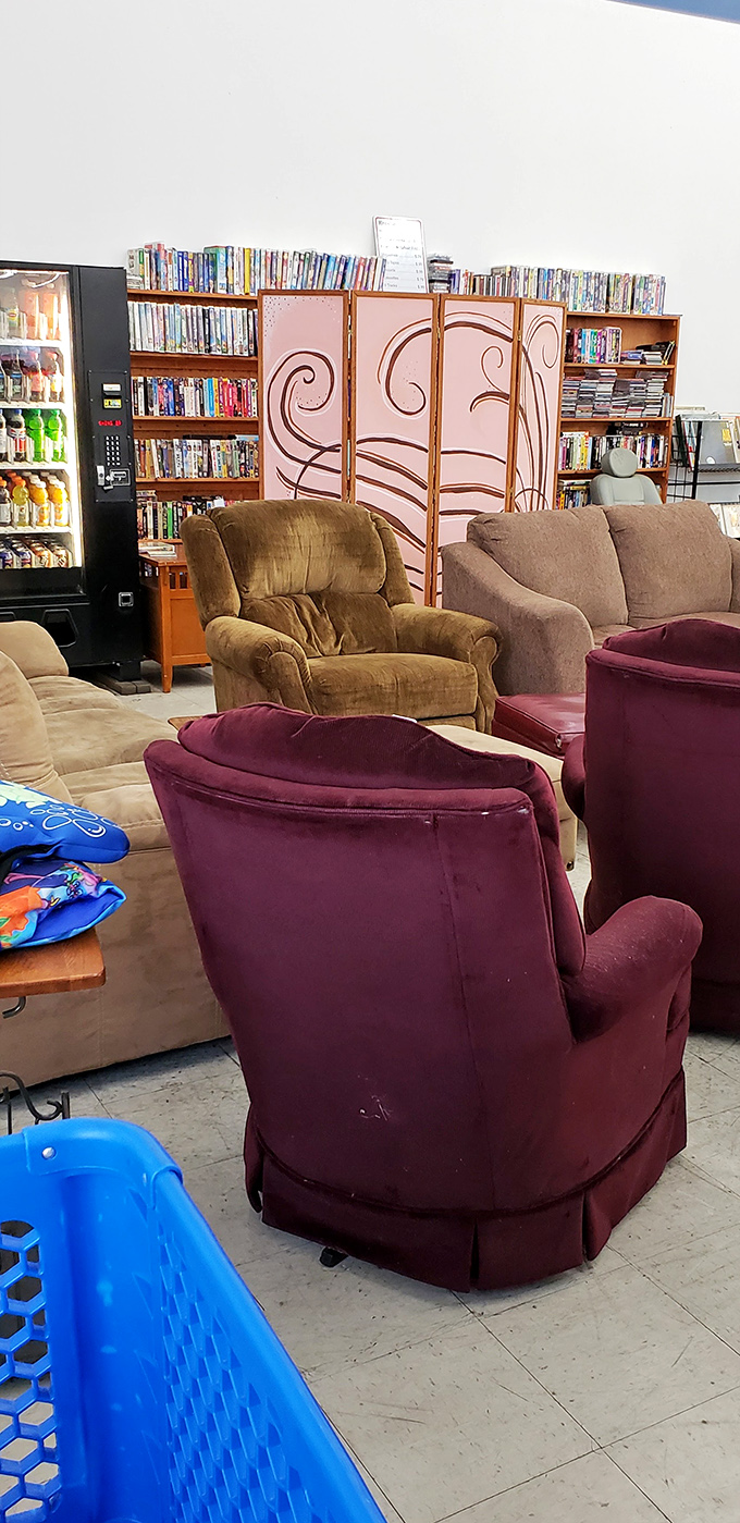 The furniture section: where velvet recliners and bookshelves create impromptu living rooms. That burgundy chair has seen some stories.