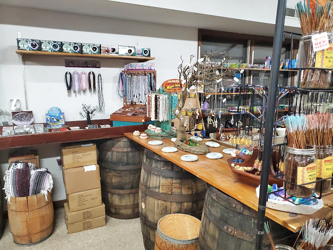 Rustic wooden barrels create the perfect stage for displaying handcrafted jewelry and trinkets - farmhouse elegance meets mountain treasure.