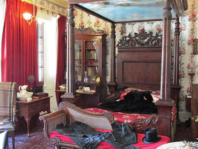 A bedroom fit for Victorian nobility, where the four-poster bed and floral wallpaper suggest dreams were more ornate back then. Even the ceiling is painted sky-blue!