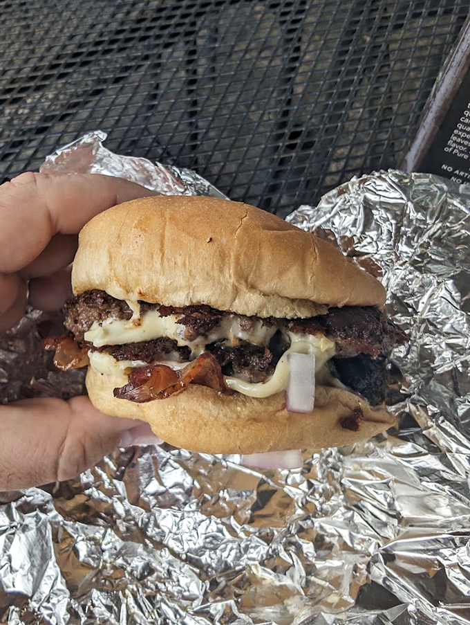 Not just a burger but a sacred contract between beef and cheese, sealed with a perfect char that would make backyard grill masters weep with joy.