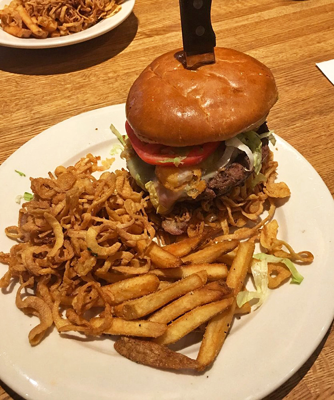 This isn't just a burger&mdash;it's a towering monument to American excess, complete with crispy onion strings that should be classified as addictive substances.