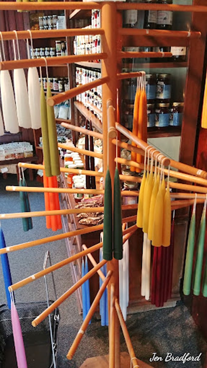 A rainbow of hand-dipped candles stands at attention, each one promising to cast a warm glow that no mass-produced lighting could ever match.