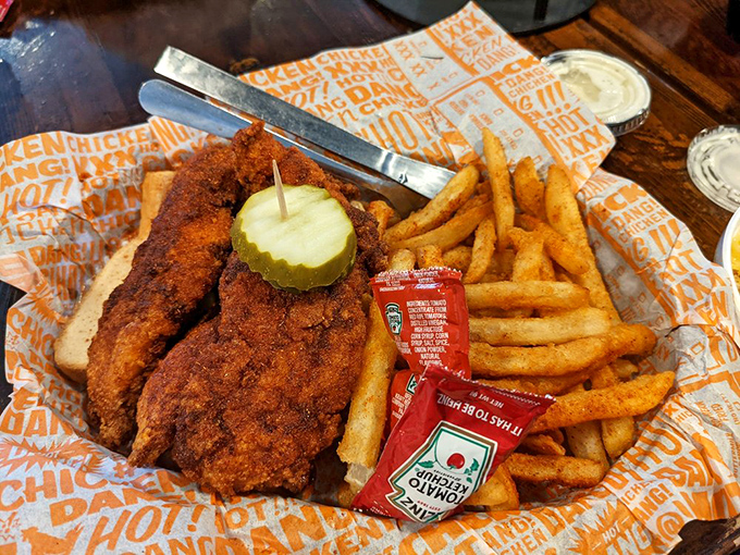 A basket of golden treasures with fries and pickle&mdash;the holy trinity of fast-casual dining. Ketchup packets stand by for optional assistance.