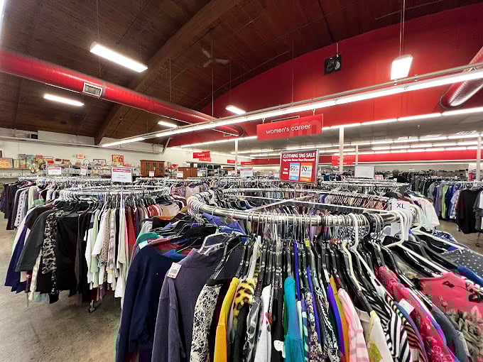 Women's Corner: the epicenter of fashion archaeology where patient hunters unearth designer labels beneath fluorescent lights.