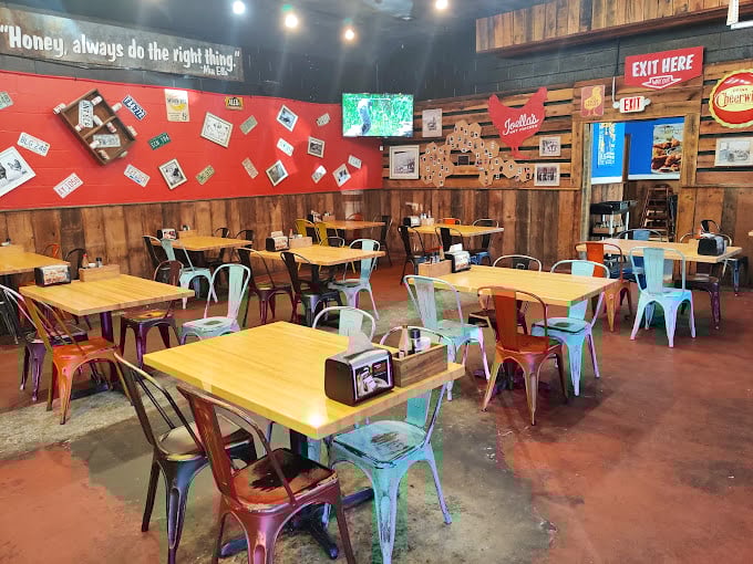 Not just tables and chairs, but command centers for spice enthusiasts. The wooden walls and colorful metal seating create a space that's both rustic and refreshingly modern.