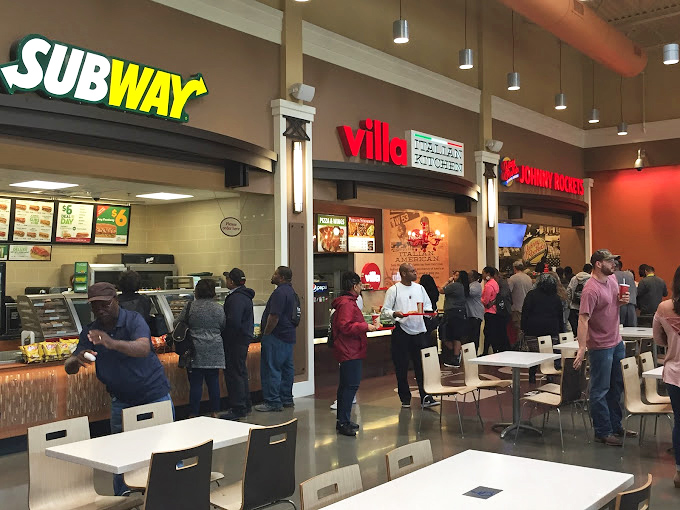 The food court buzzes with shoppers taking a well-earned break, fueling up on everything from subs to Villa Fresh Kitchen specialties.