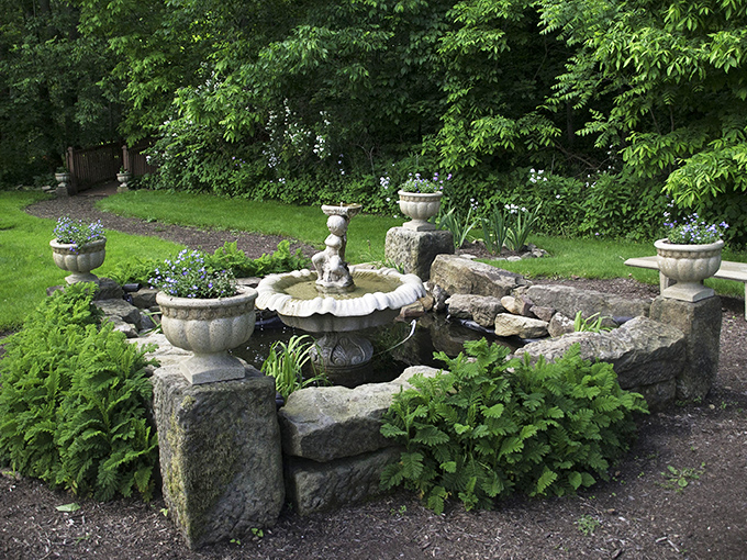 This garden fountain doesn't just circulate water&mdash;it circulates tranquility, surrounded by stone that's witnessed more seasons than most history books.