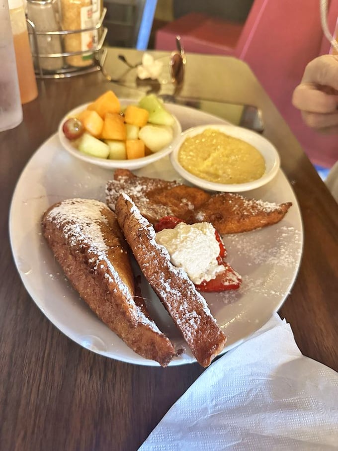 French toast that crosses into dessert territory without apology, flanked by fresh fruit that almost&mdash;almost&mdash;makes you feel virtuous about the whole affair.