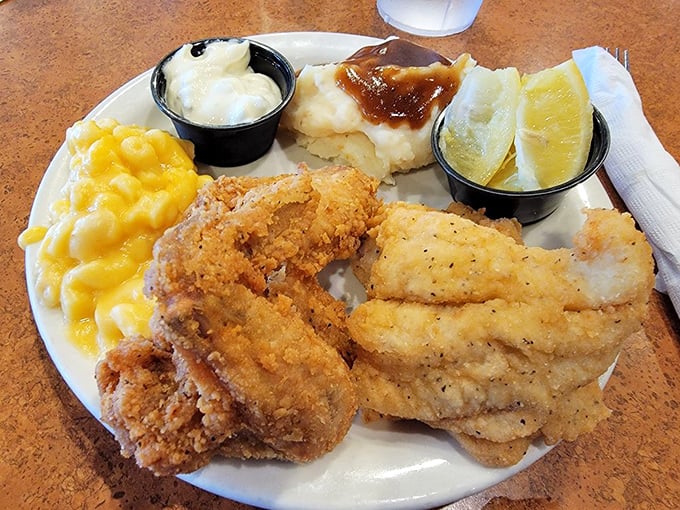 The holy trinity of Southern comfort: mac and cheese, perfectly fried chicken, and fish that would make a pescatarian reconsider their life choices.