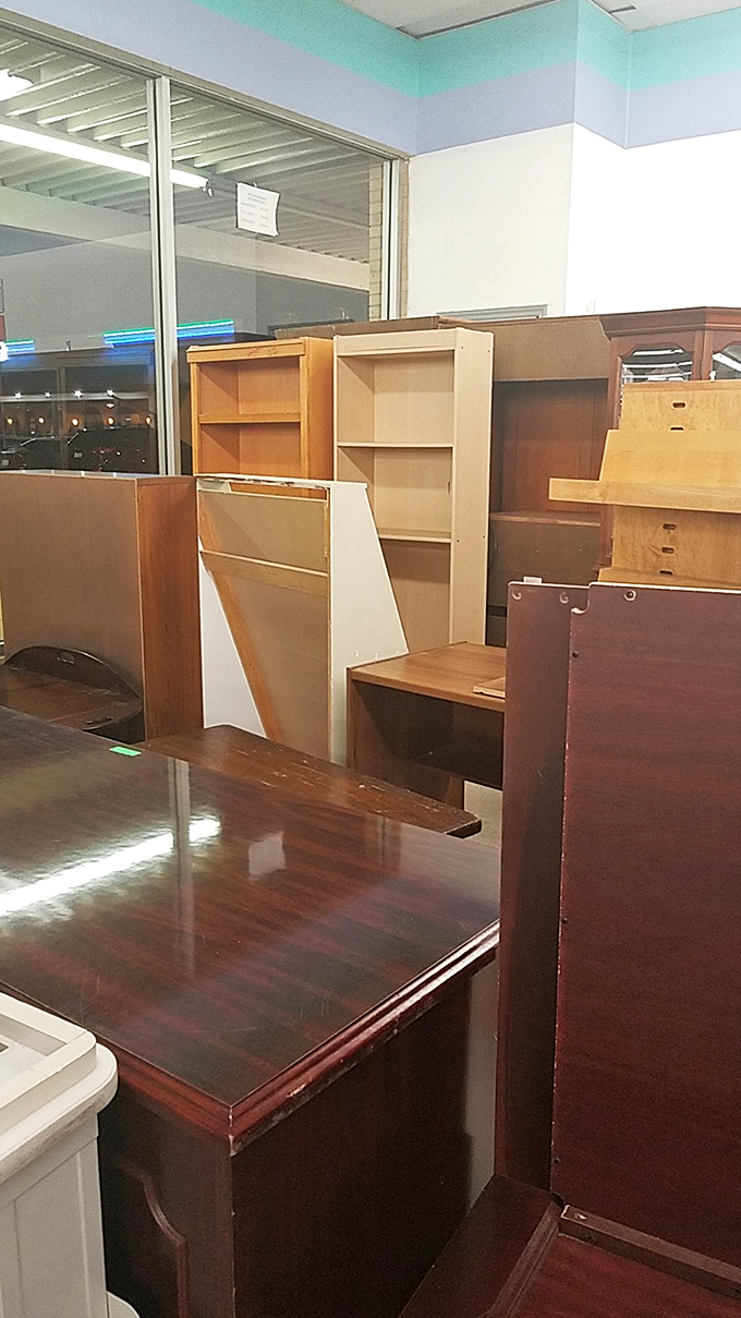 A wooden furniture forest where mid-century treasures hide among practical pieces. Every desk has chapters yet to be written.