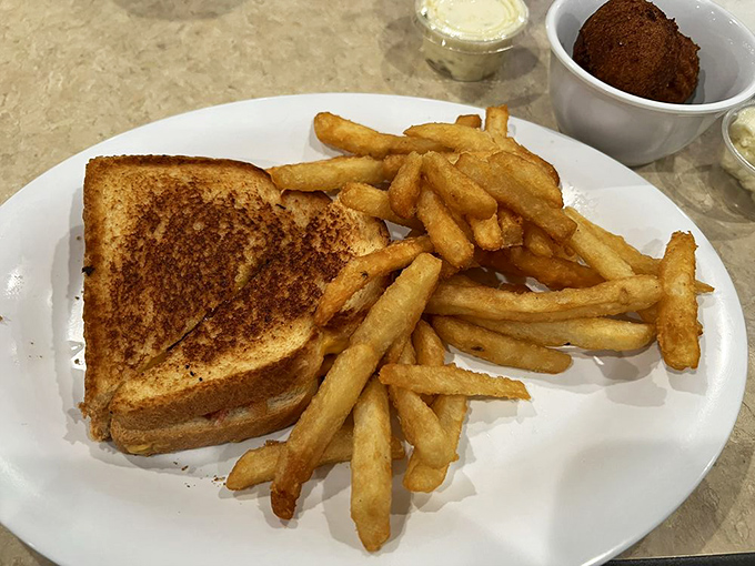 Grilled cheese and fries &ndash; childhood comfort with adult execution. The sandwich practically whispers, "Everything's going to be okay."