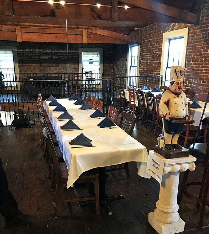 The private dining room stands ready for celebration, complete with what appears to be the restaurant's stoic culinary mascot standing guard over your special occasion.