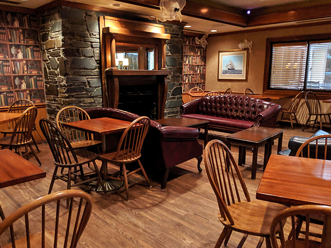 Where book wallpaper, stone fireplaces, and comfortable seating combine to create a dining room that feels less like a restaurant and more like your favorite uncle's den.