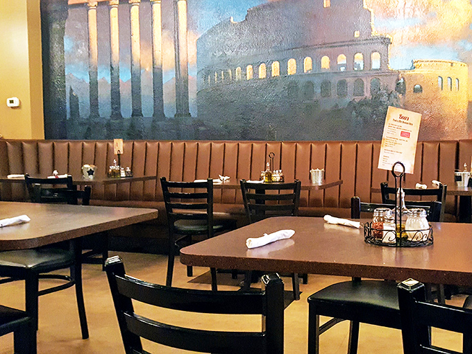 The Roman Colosseum mural watches over diners like a painted chaperone, reminding you that great food has always been worth gathering for.