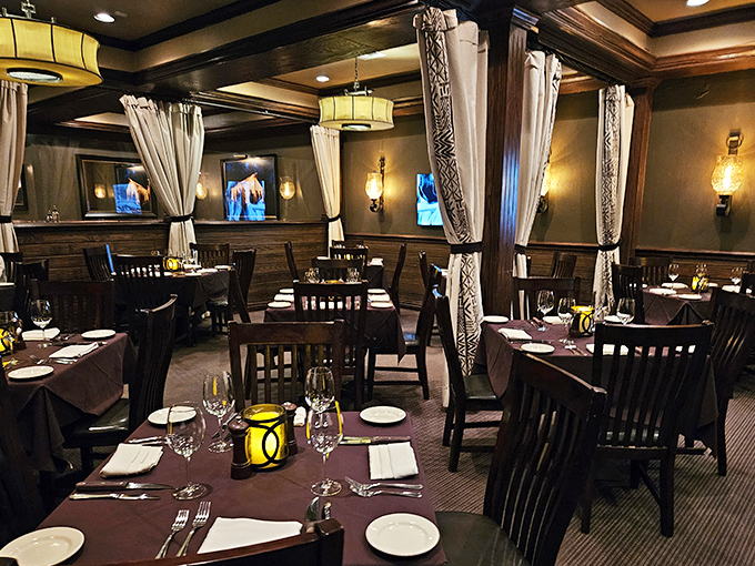 The dining room balances masculine steakhouse energy with elegant touches, creating an atmosphere where both celebration and serious eating can coexist beautifully.