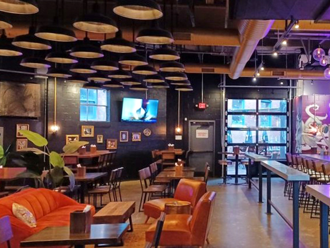Industrial chic meets cozy comfort&mdash;exposed ductwork overhead while the warm wood tones below say "stay awhile, order dessert."