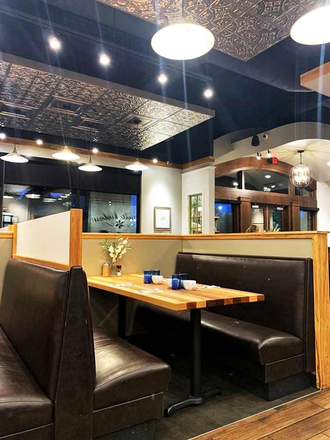 Those pressed tin ceiling details deserve their own HGTV special. The thoughtful lighting and booth design create intimate dining islands in a sea of breakfast enthusiasm.