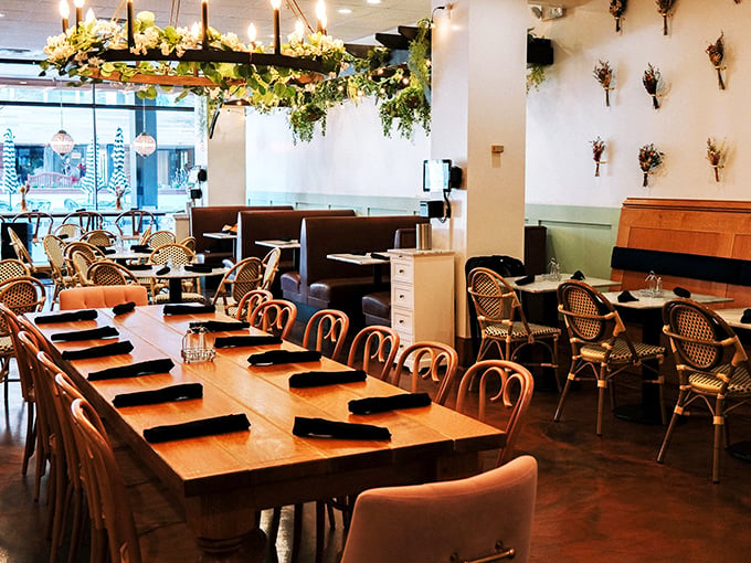 A communal table that says "come as strangers, leave as friends." Those hanging plants are living their best life, just like you will after brunch.