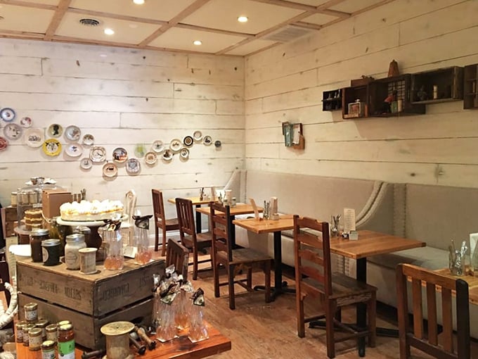 A corner of the cafe where decorative plates become wall art and wooden crates transform into display stands. Shabby-chic before it was a Pinterest category. 