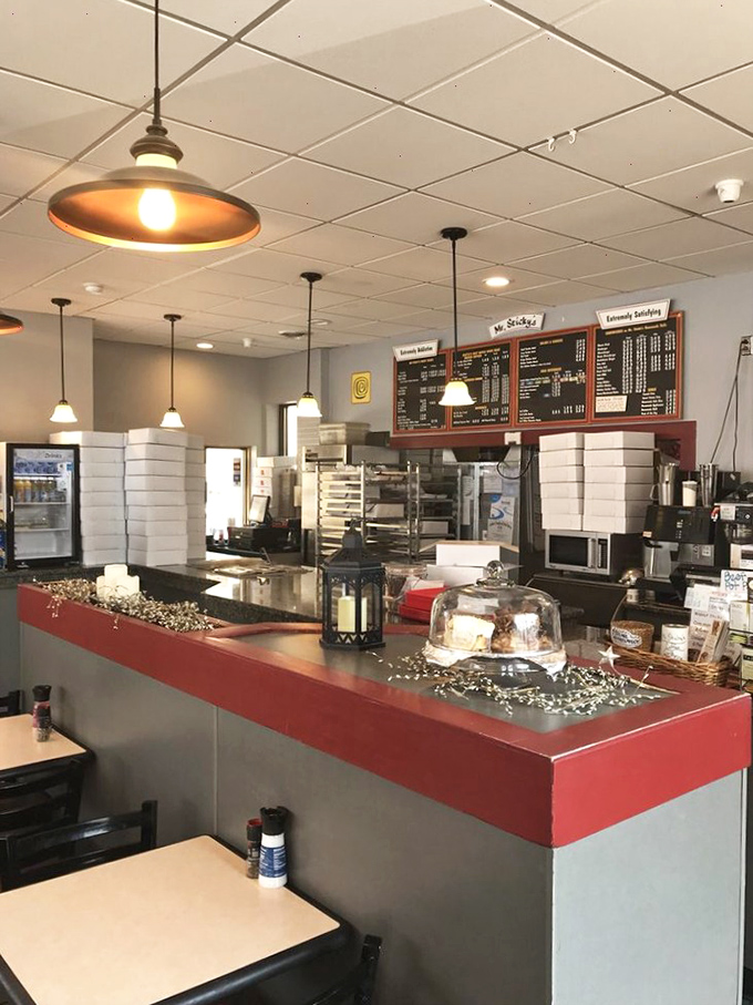 The red counter serves as mission control for pastry distribution, while pendant lights hang like halos over this temple of temptation.