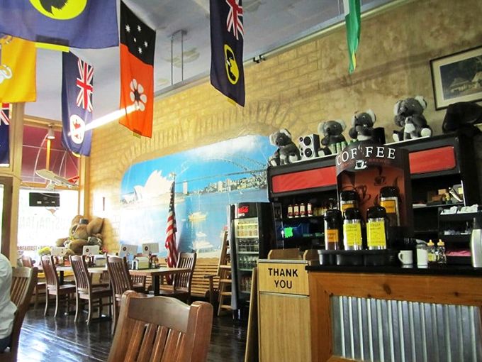 Flags hang like friendly sentinels above the coffee counter, where espresso machines hum the universal language of caffeine.