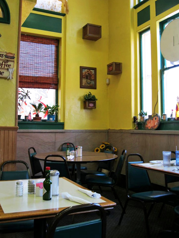 Tall windows bathe the dining area in natural light, while whimsical touches on cheerful walls remind you this isn't your standard cookie-cutter cafe.
