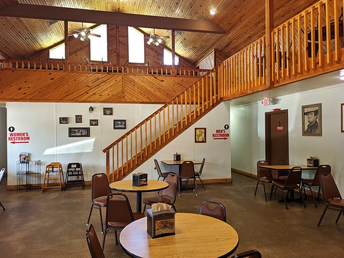 Simple tables, wooden accents, and zero pretension. This dining room says, "We put all our effort into the pies, not the chandeliers."