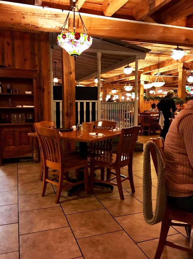 Stained glass chandeliers cast a warm glow over wooden beams and tables where memorable meals unfold like cherished family stories.