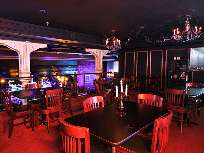 Cobwebs drape from chandeliers while purple lighting transforms this space into the dinner party Vincent Price always wanted to host. 