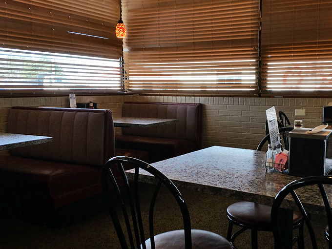 Wooden booths, warm lighting, and amber-tinted blinds create the perfect backdrop for serious chicken contemplation and consumption.