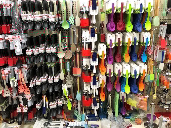 A kaleidoscope of kitchen tools dangles before you – every utensil imaginable in colors that would make a rainbow jealous.