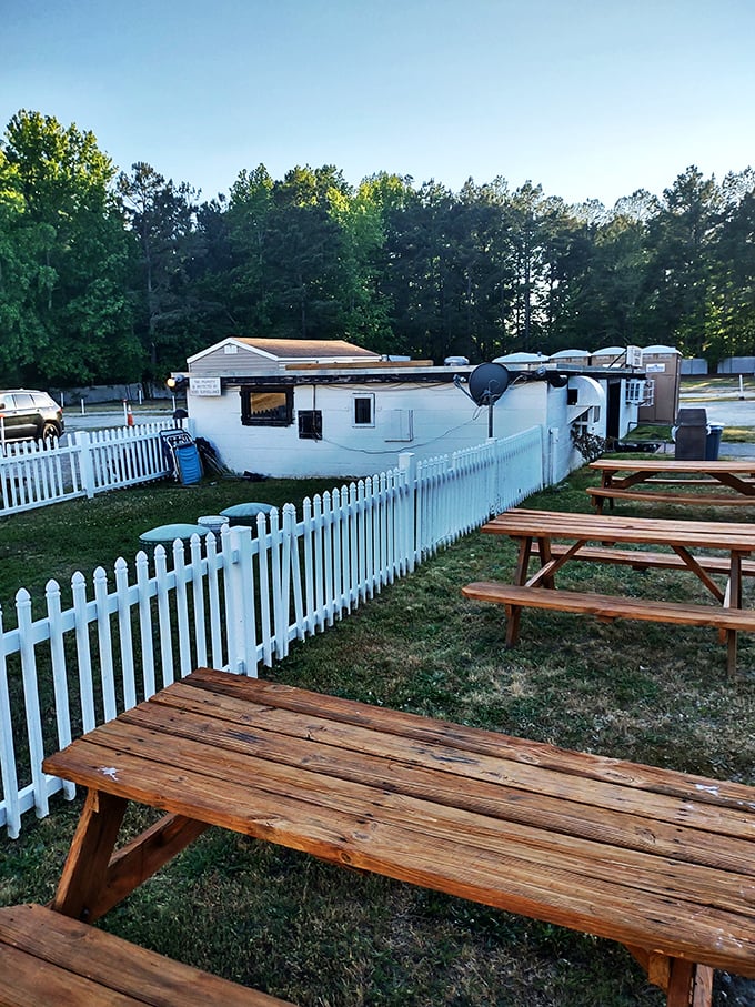 Beyond the white picket fence, wooden picnic tables offer the perfect spot for pre-movie meals and intermission stretches.