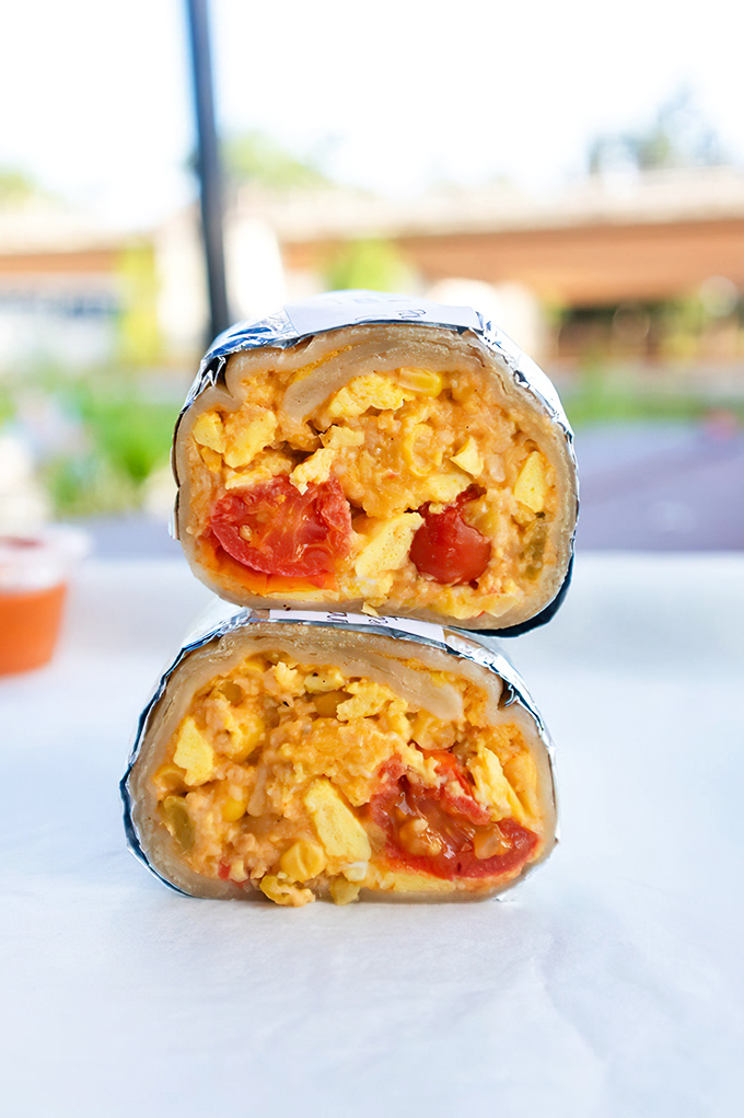 A masterclass in color and composition. The green salsa alongside provides the perfect acidic counterpoint to the rich, egg-forward filling.