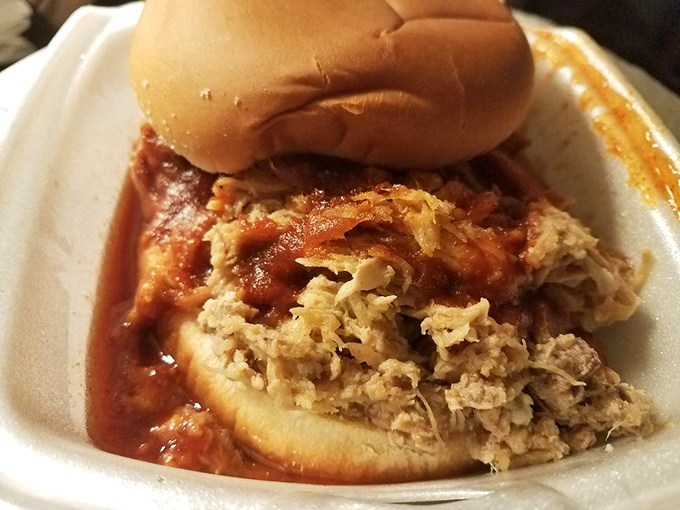 This pulled pork sandwich isn't just lunch; it's a saucy ambassador for Indianapolis barbecue culture, spilling over with juicy promise.