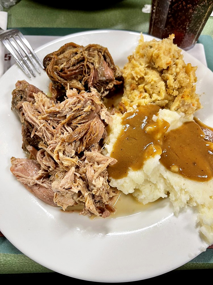 Roast beef so tender it practically surrenders at the sight of your fork, alongside mashed potatoes swimming in gravy deep enough to need a lifeguard.
