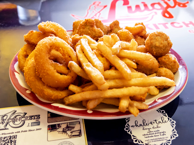A plate that answers the eternal question: "Why choose between onion rings and fries when coexistence is this delicious?"