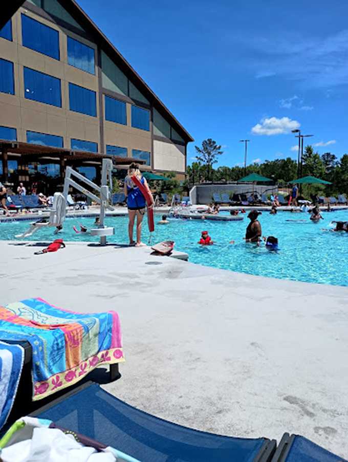 The exterior view showcases the resort's impressive architecture alongside the outdoor pool area &ndash; rustic lodge meets aquatic playground.