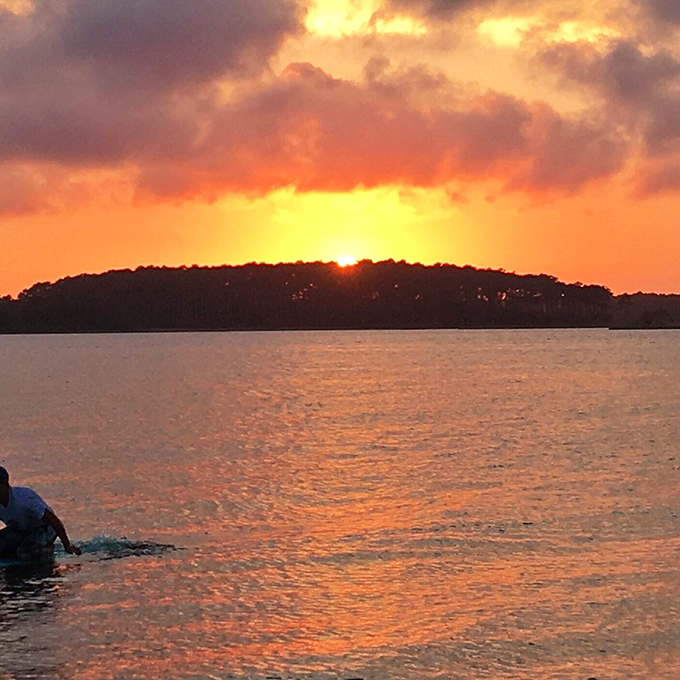 Nature's nightly masterpiece over Little Assawoman Bay&mdash;the kind of sunset that makes everyone temporarily forget their phones exist.