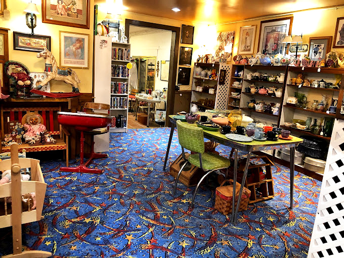That vibrant blue carpet could tell tales of treasure hunters who've walked its path. Mid-century modern meets timeless charm around that retro table.