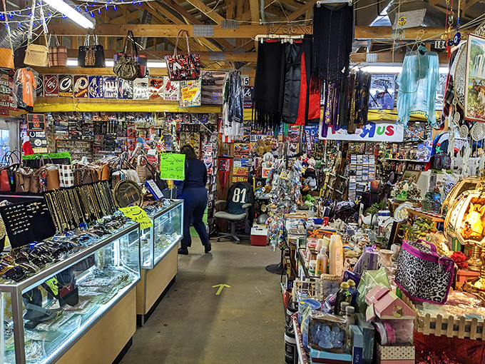 Organized chaos reigns in this vendor's booth, where sports memorabilia, jewelry, and nostalgic trinkets compete for shoppers' attention and affection.