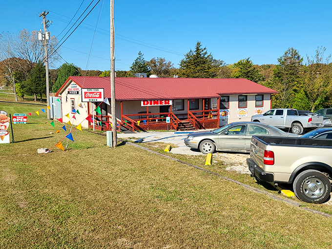 Those cheerful hanging baskets frame a diner where pie crust secrets have been kept for generations.